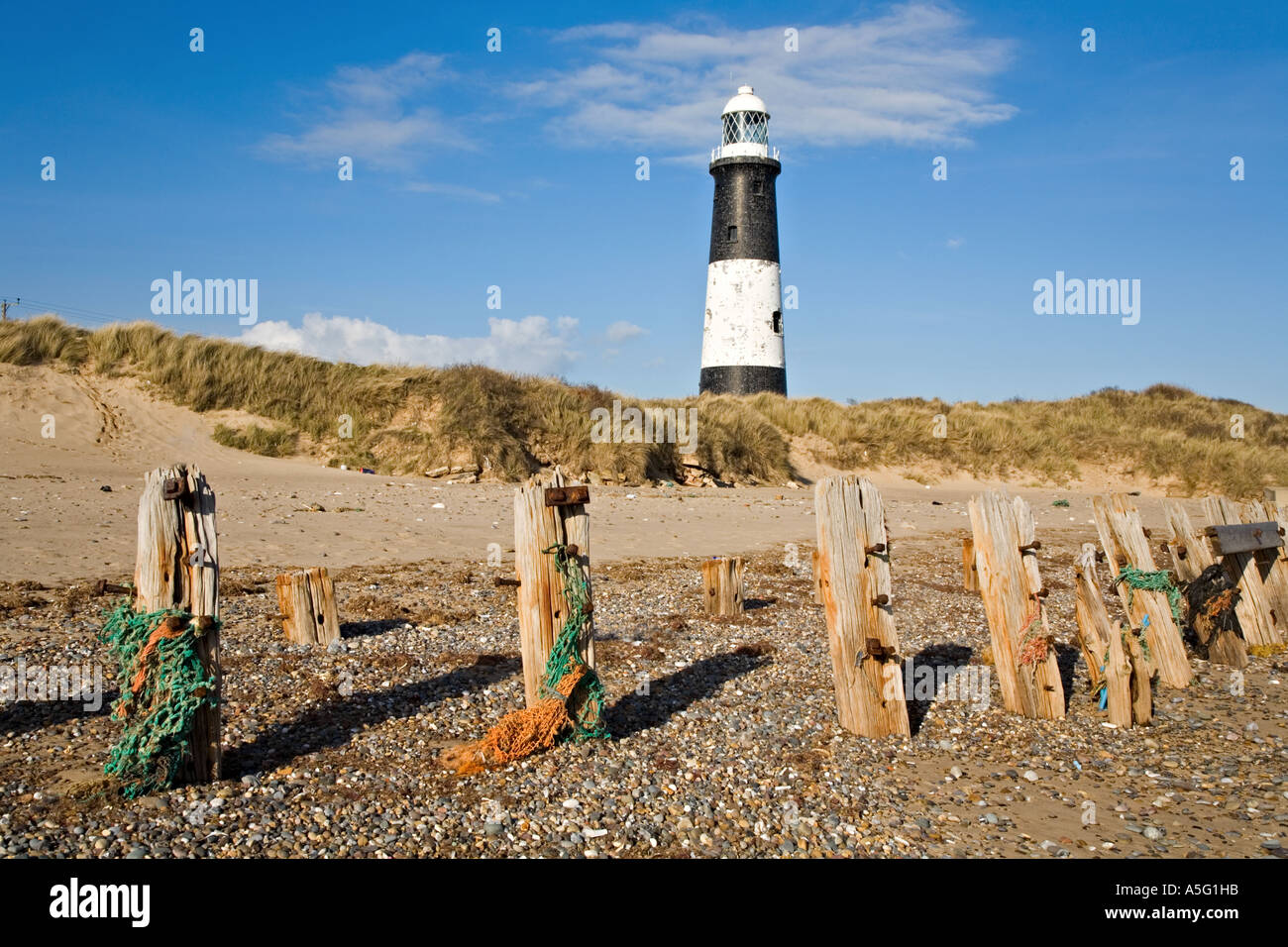 High Lighthouse 1895 and remains of wooden groyne sea defences at Spurn ...