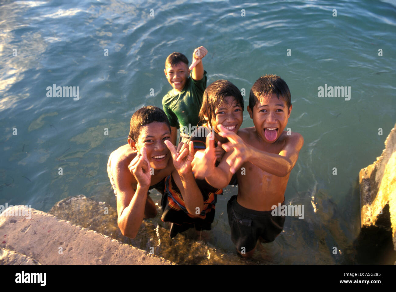 Tonga Haapai Pangai Joyful children playing in the harbour Stock Photo ...