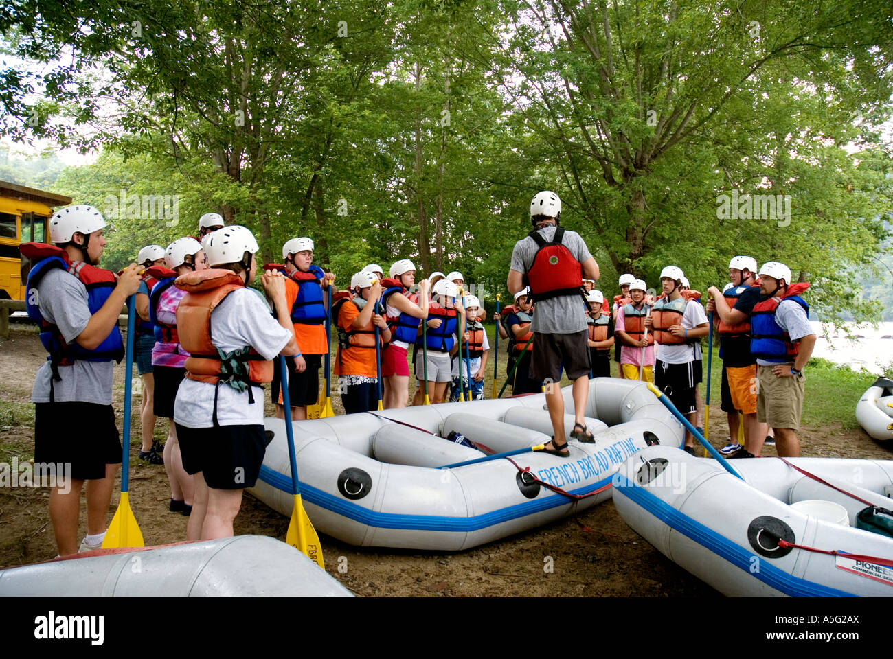 Whitewater rafters listen as their guide gives a safety talk before a ...
