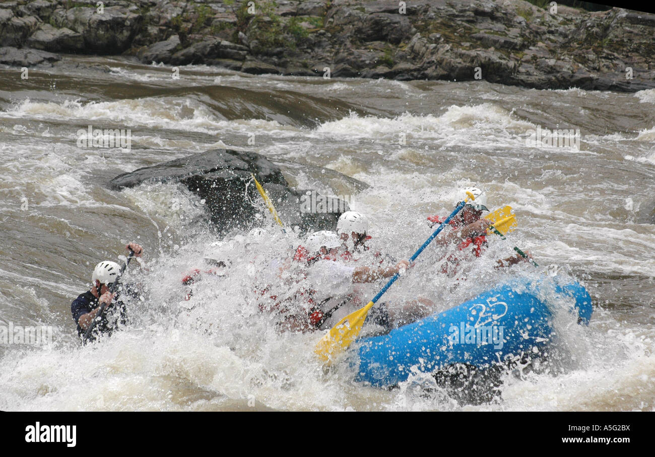 Whitewater rafters experience high adventure as they splash through a ...