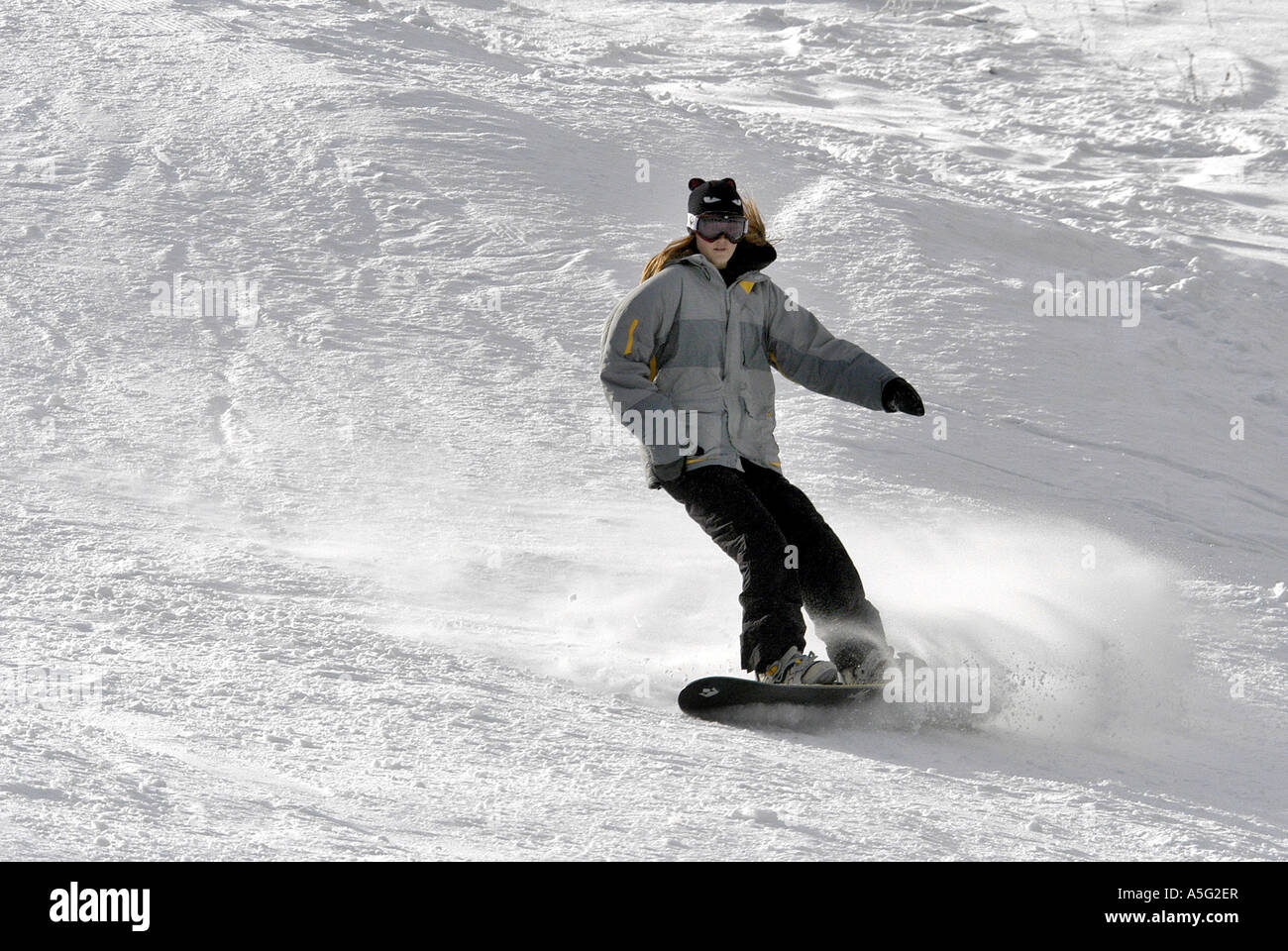 Young woman snowboarder on downhill slope Stock Photo - Alamy