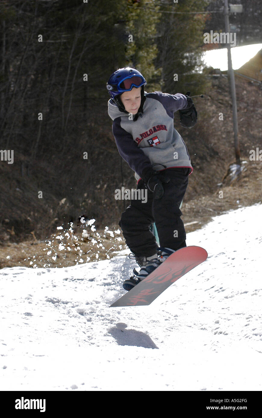 Young boy snowboarder jumping Stock Photo - Alamy