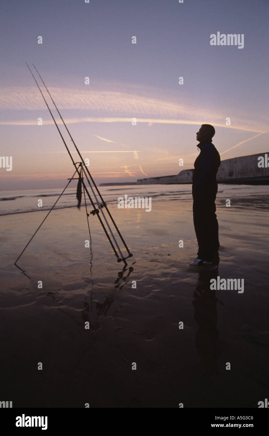 beach angler fisherman fishing for sea bass sunset dusk birling gap ...