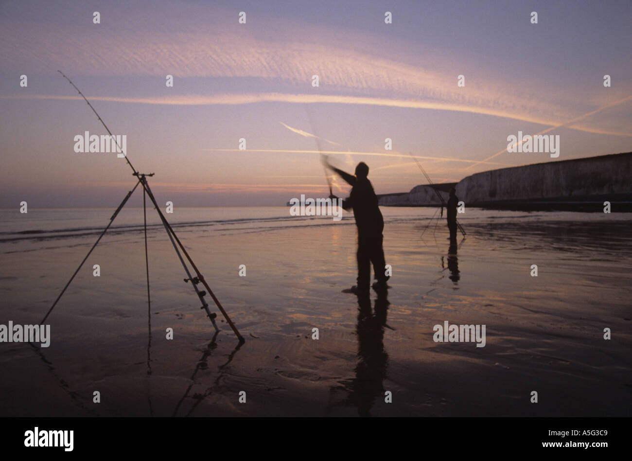 beach angler fisherman fishing for sea bass sunset dusk birling gap ...