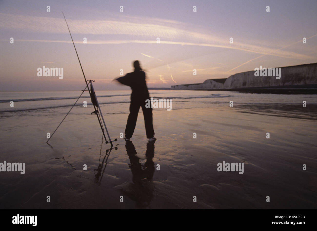 beach angler fisherman fishing for sea bass sunset dusk birling gap ...