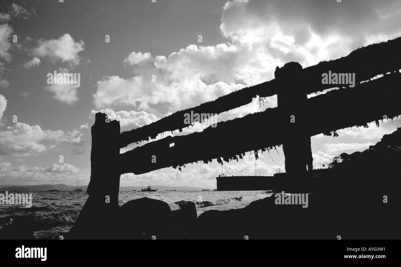 Wooden groynes on the seafront at Mumbles Swansea with the Knab Rock ...