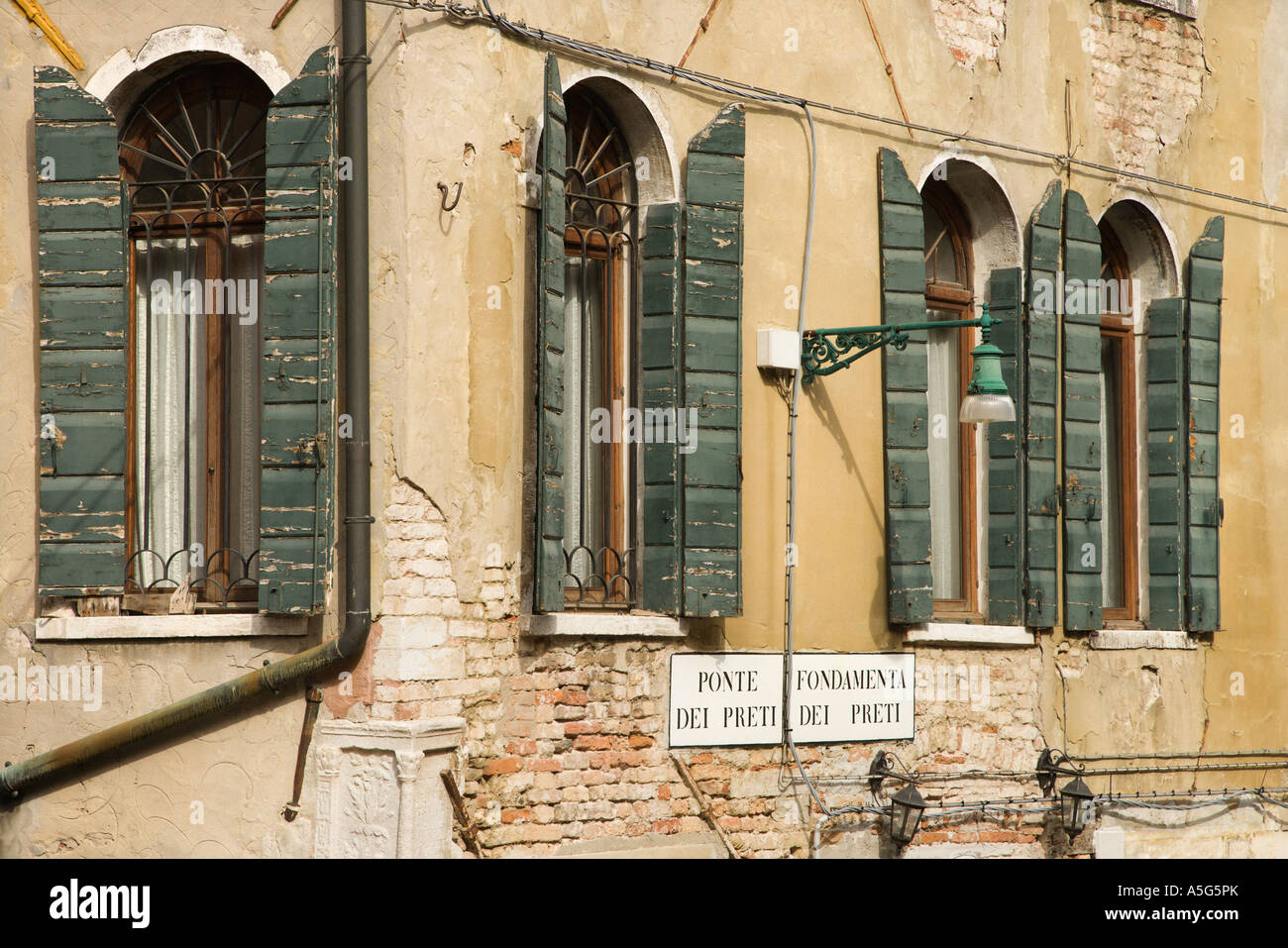 Arched windows with shutters in Venice Italy Stock Photo - Alamy