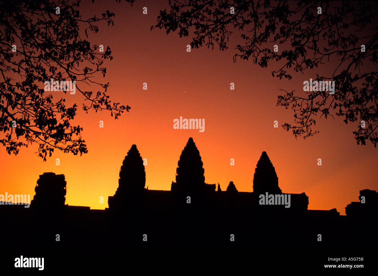The sunset at Angkor Wat is always dramatic as it outlines the ...