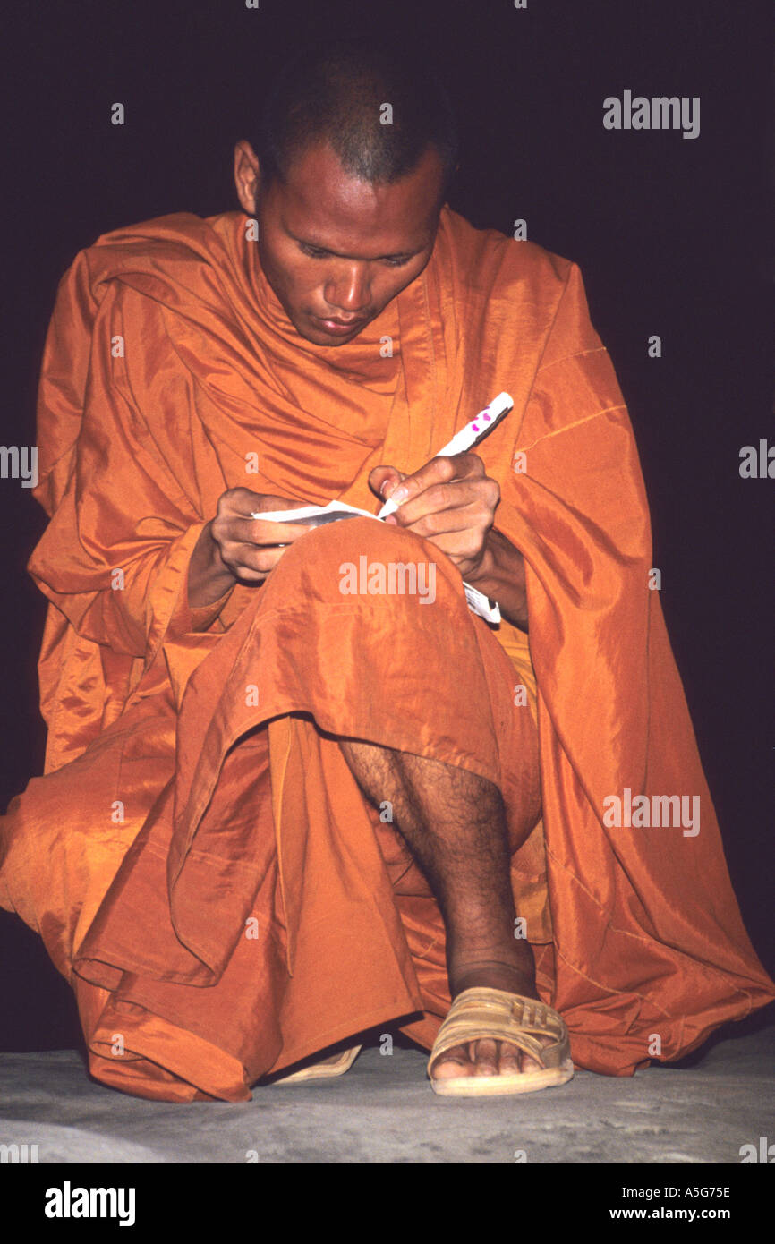 monk on saffron robes writing at Angkor Wat,Cambodia,Kampuchea Stock ...