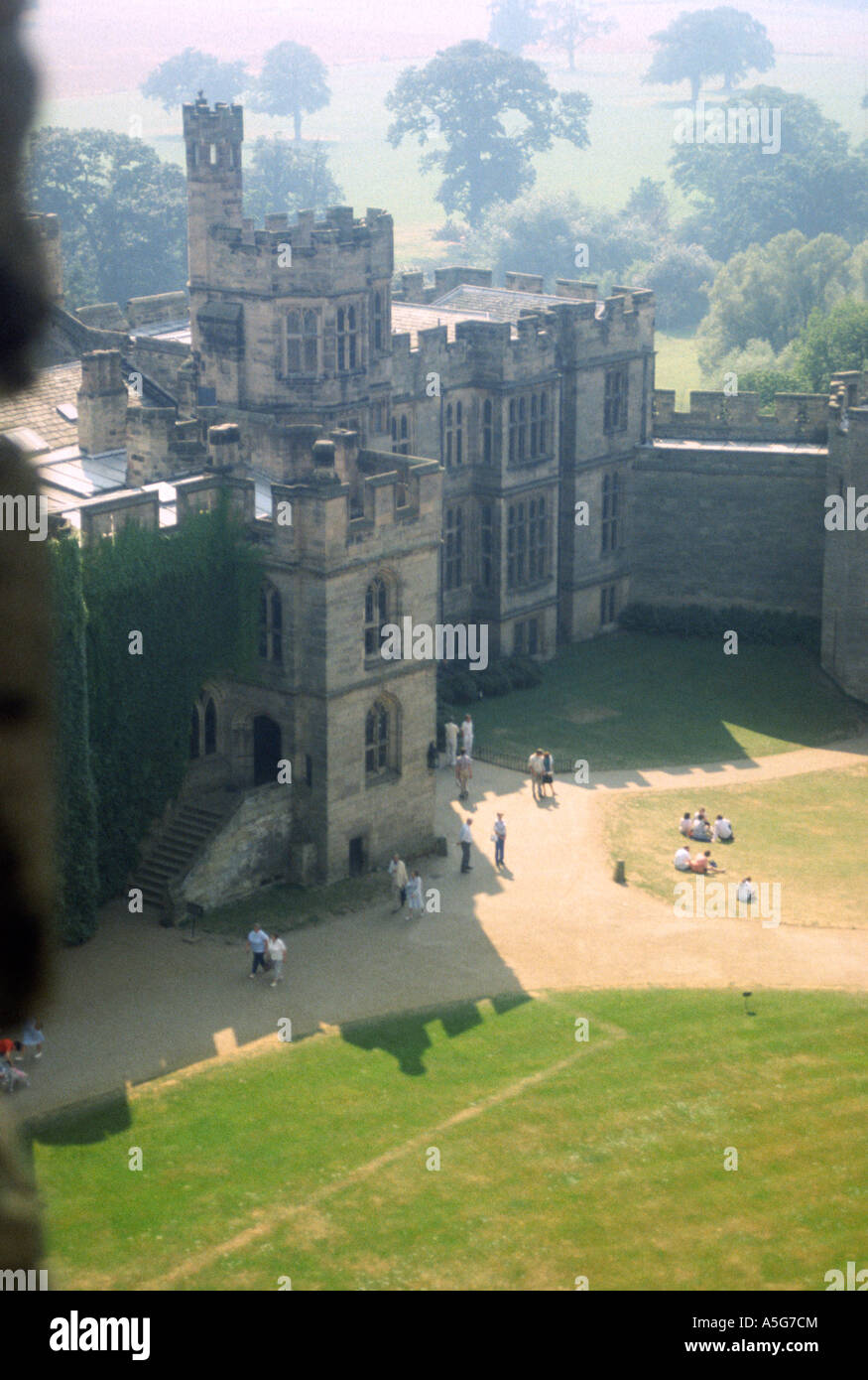 Tourists explore the grounds of Warwick Castle in Warwick, England ...