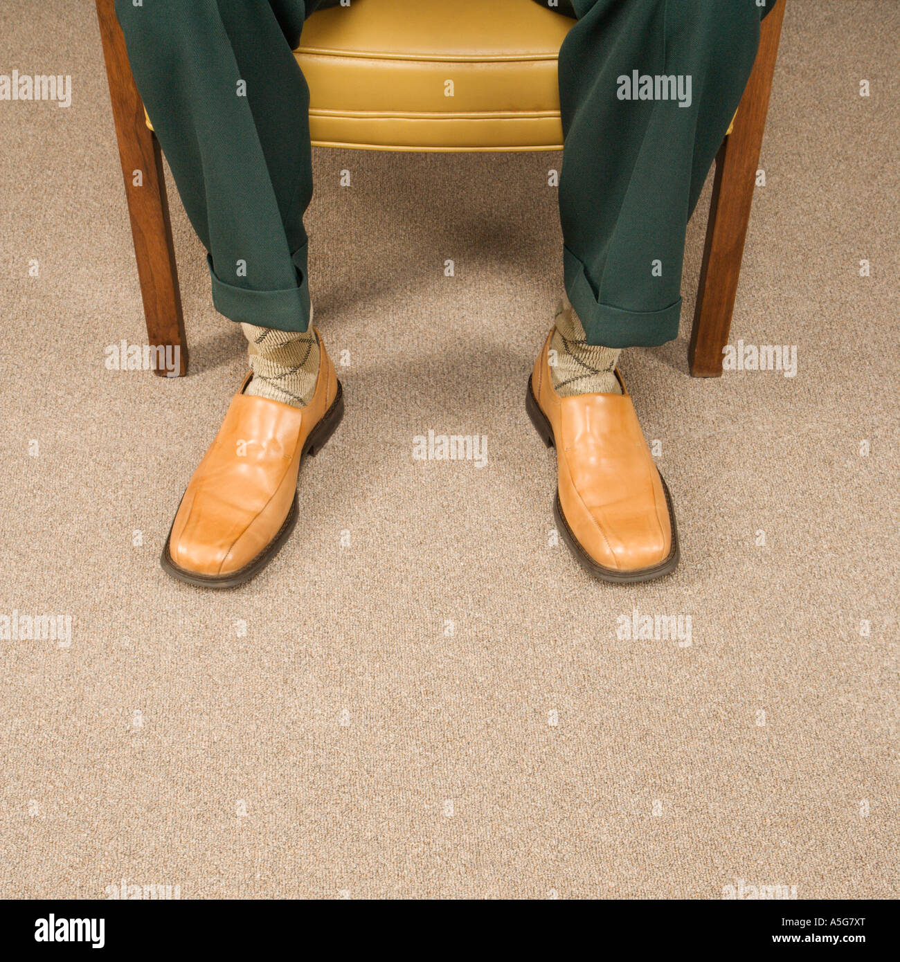 Close up of man sitting in chair wearing retro pants and shoes Stock ...