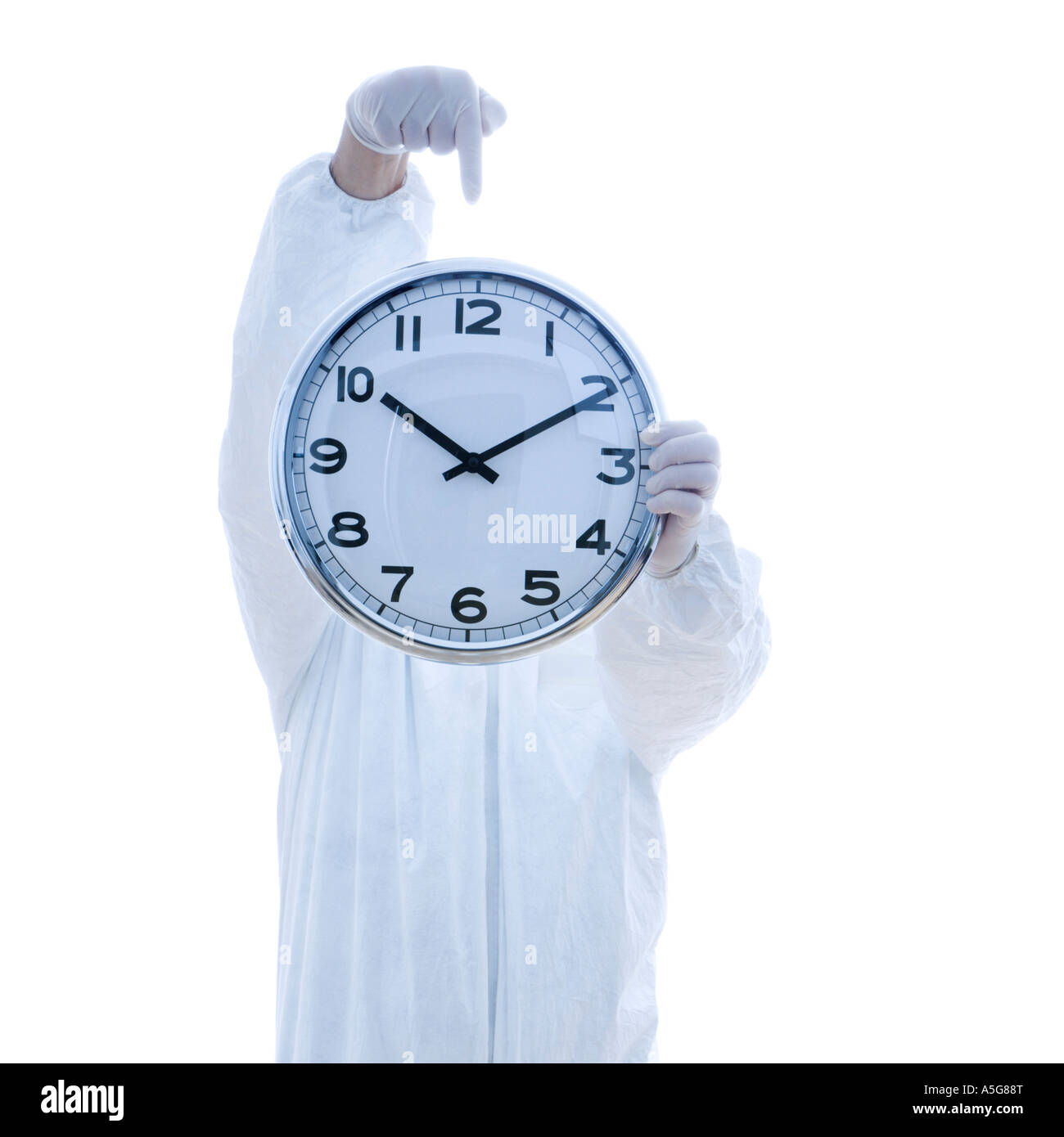 Man in biohazard suit holding clock in front of face pointing to clock ...