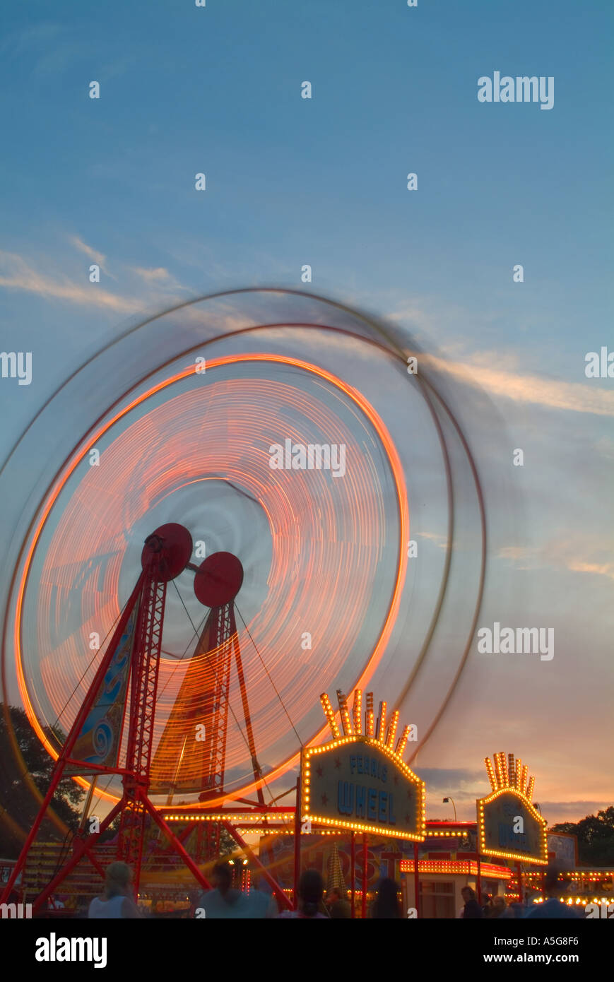 traditional fairground big wheel in motion at dusk Stock Photo - Alamy