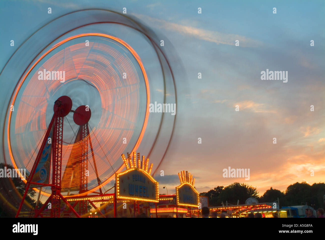 traditional fairground big wheel in motion at dusk Stock Photo - Alamy