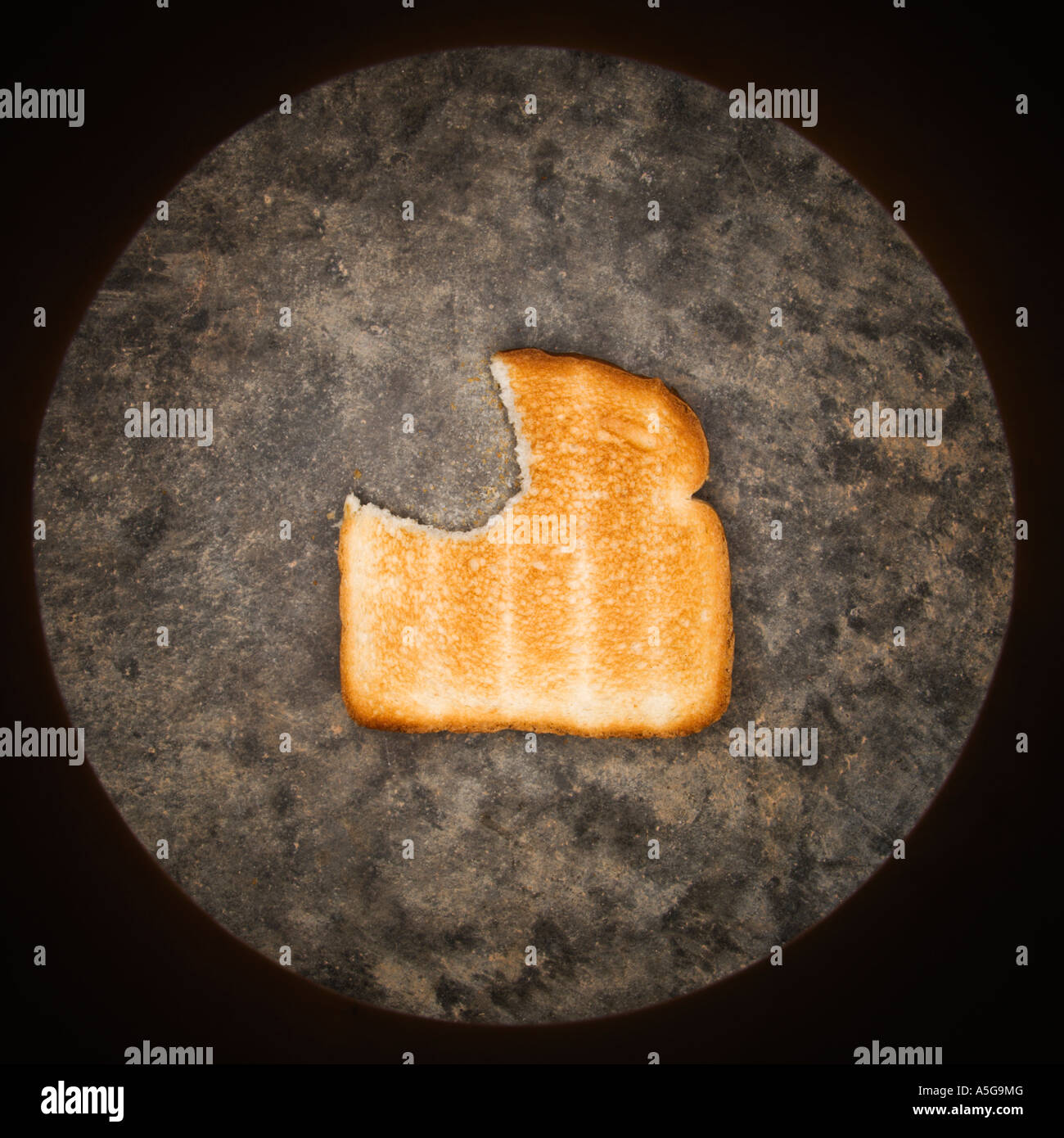 Slice of toast with bite missing Stock Photo - Alamy