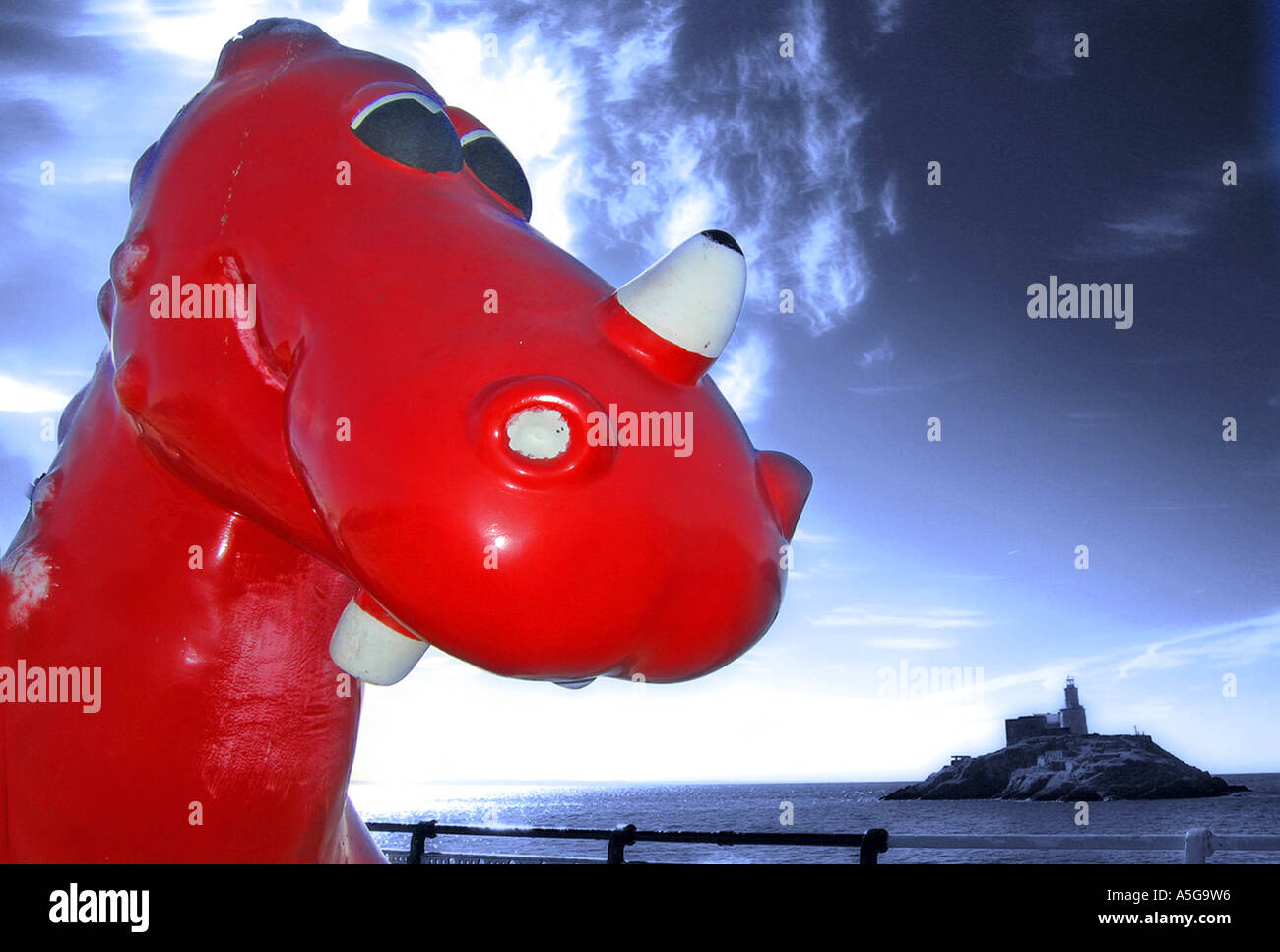 Dragon childrens slide on Mumbles pier with Mumbles lighthouse in ...
