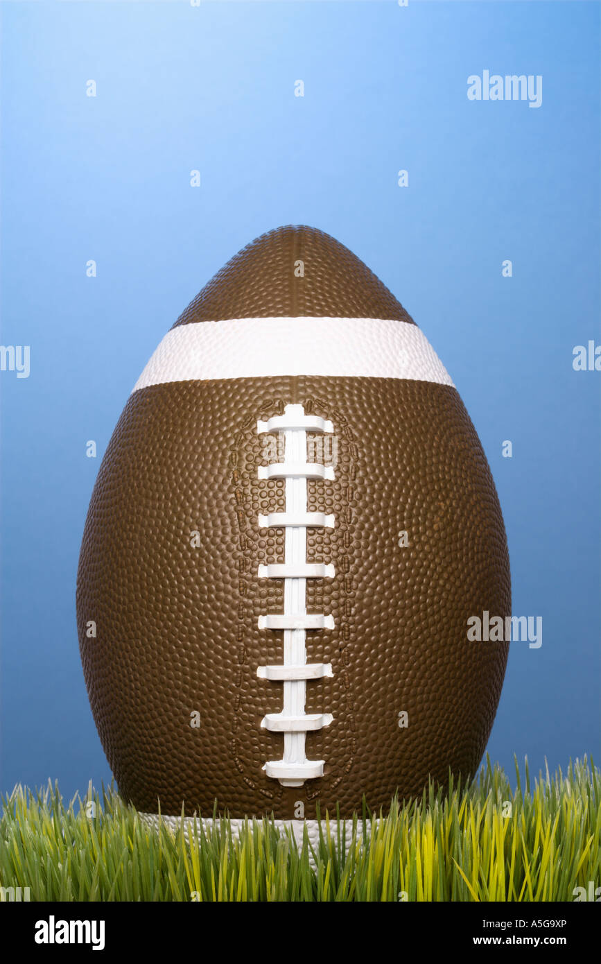 Studio shot of football resting in grass Stock Photo - Alamy