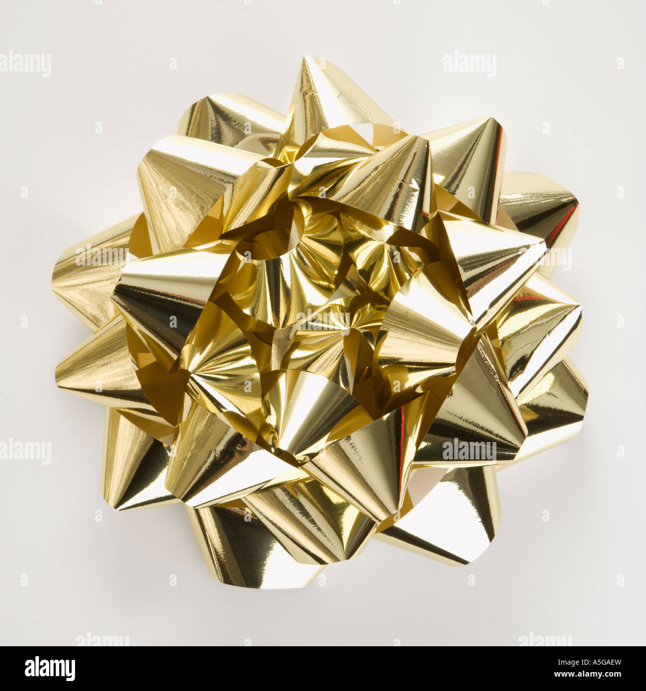 Still life of big shiny gold Christmas bow Stock Photo - Alamy