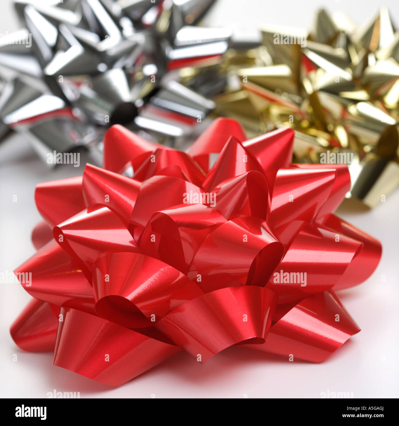 Still life of big shiny red gold and silver Christmas bows Stock Photo ...