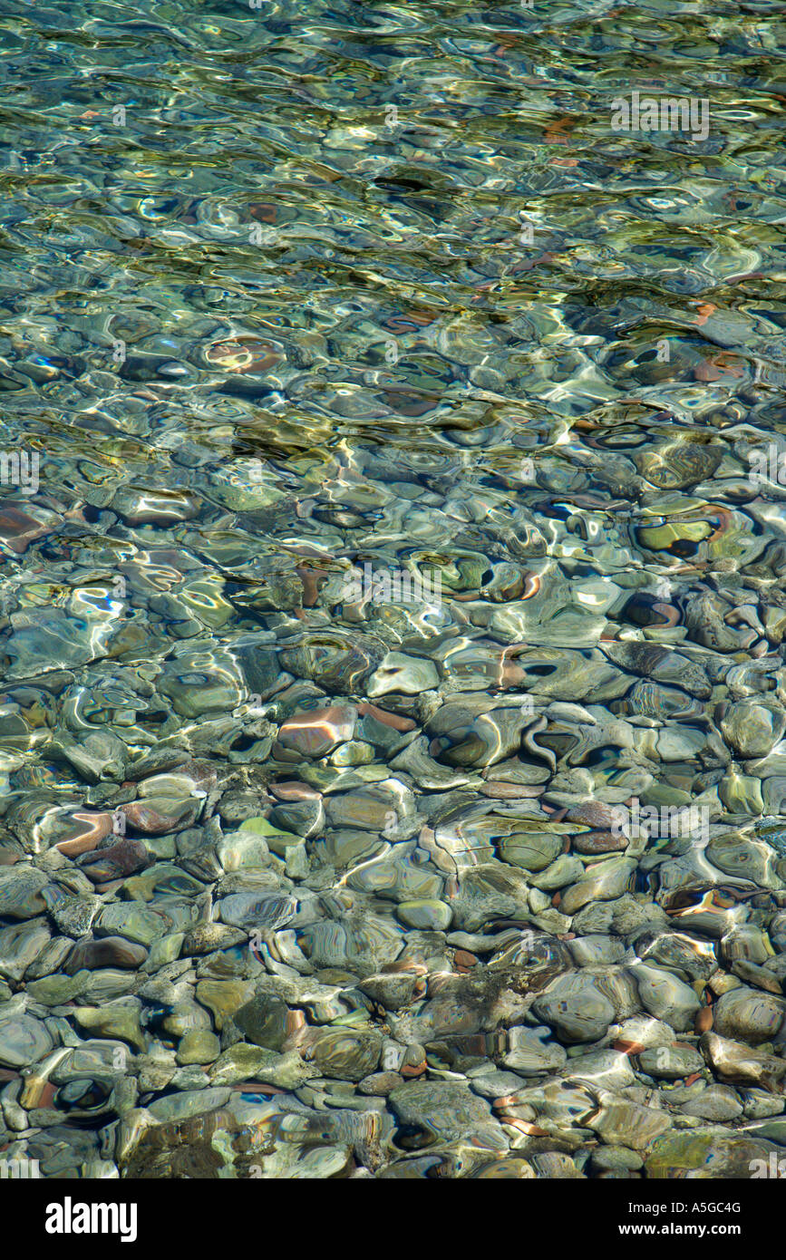 Rocks seen through rippling clear water Stock Photo - Alamy