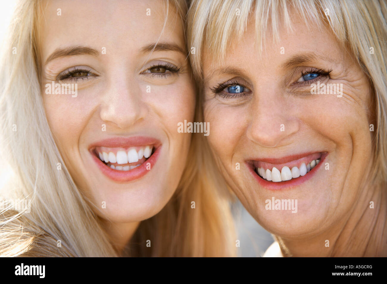 Portrait of Caucasian mother and daughter laughing and making eye ...