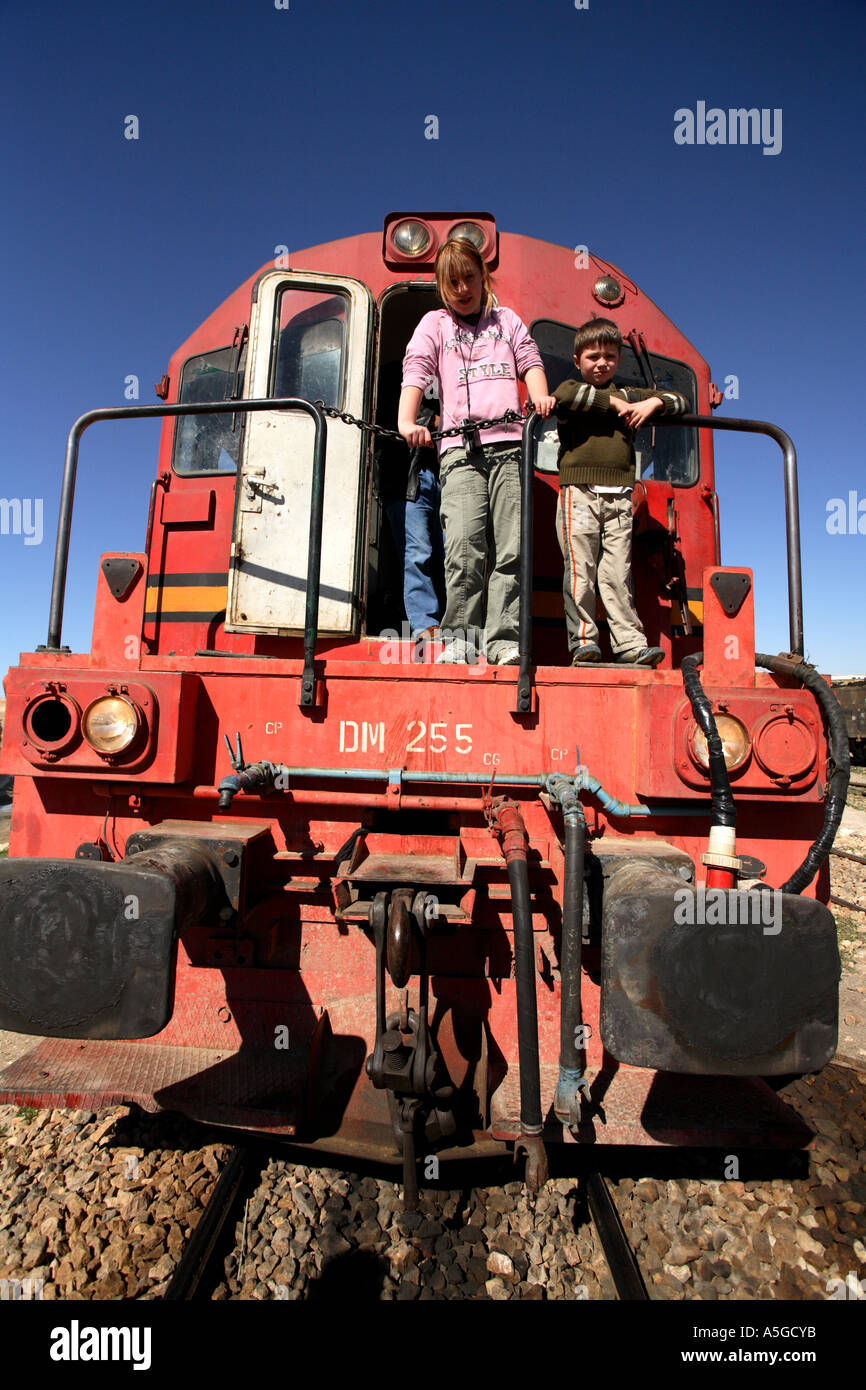Vertical portrait of young child tourists on the engine of the Red ...