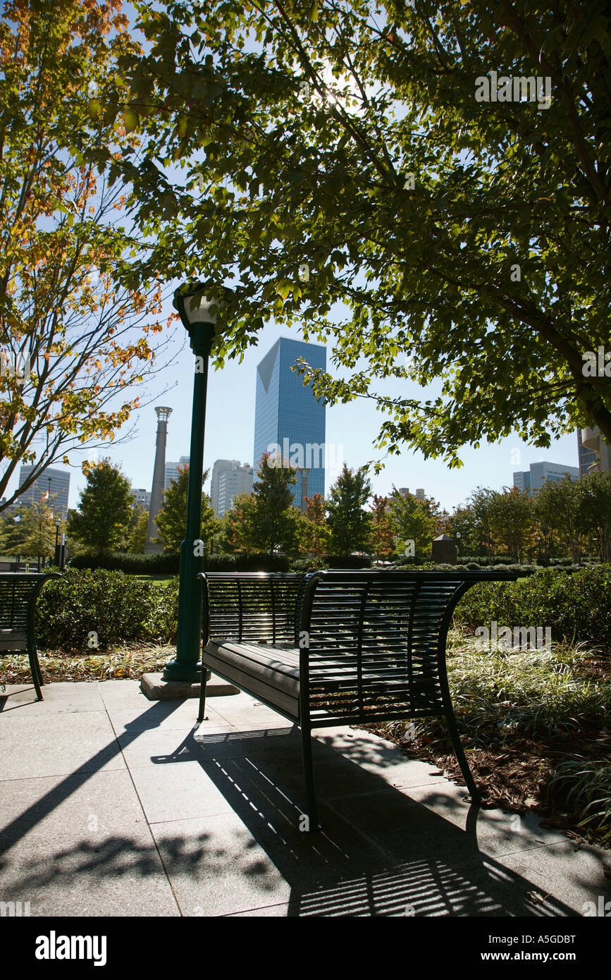 Empty bench in urban park in Atlanta Georgia with buildings in ...