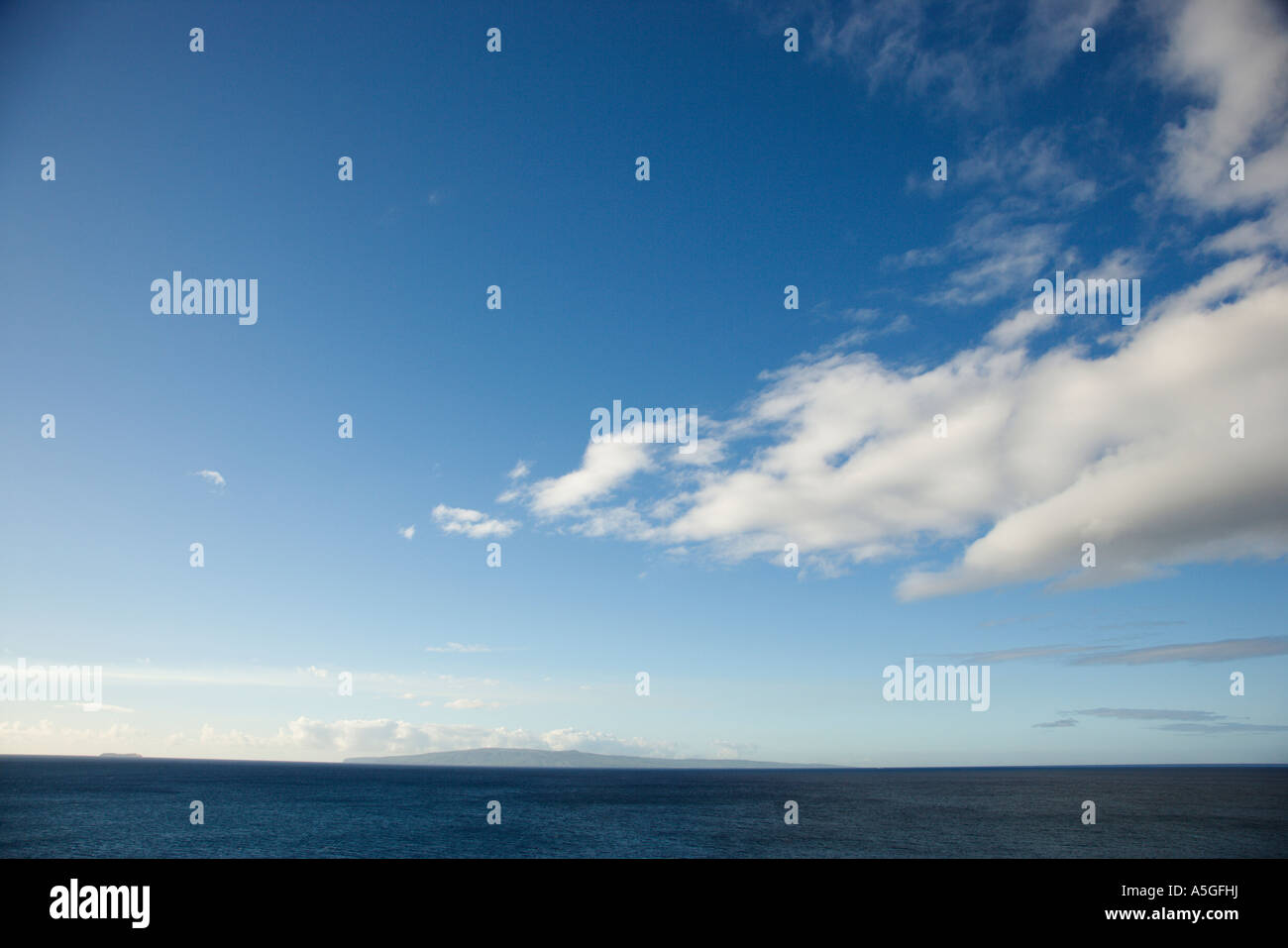 Blue sky with fluffy white clouds over ocean horizen Stock Photo - Alamy