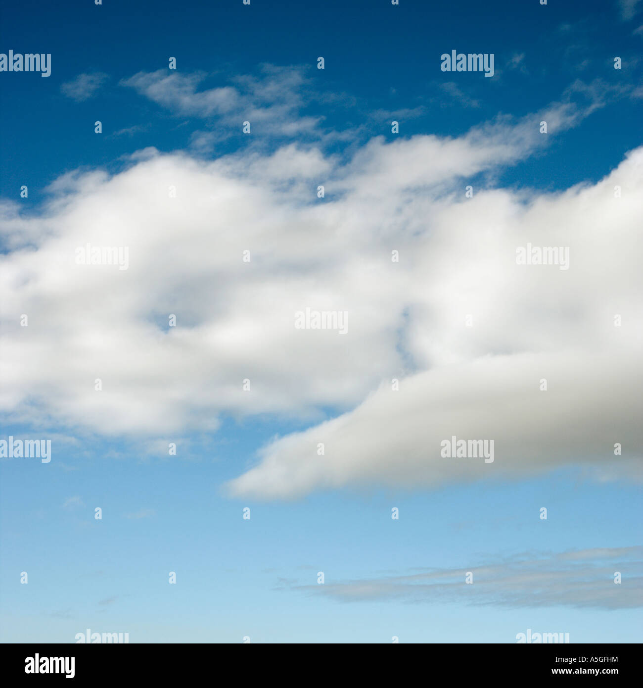 Fluffy white clouds in blue sky Stock Photo - Alamy