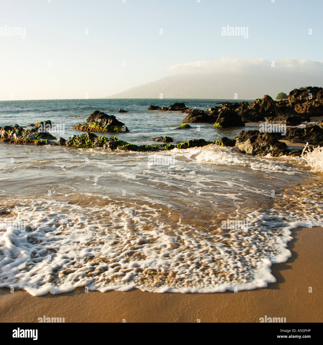 Landscape of waves lapping on rocky beach Stock Photo - Alamy