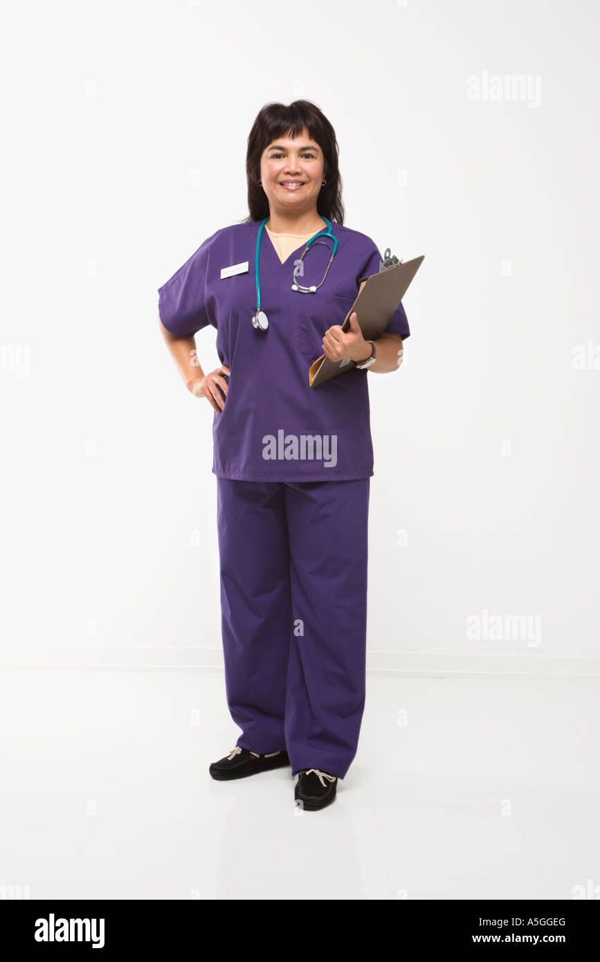 Middle aged Filipino woman dressed in scrubs with stethoscope and ...