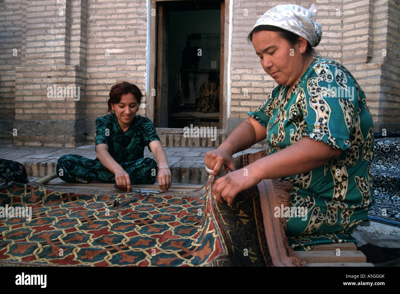 women from Chiwa base carpets, Uzbekistan, Chiwa Stock Photo - Alamy
