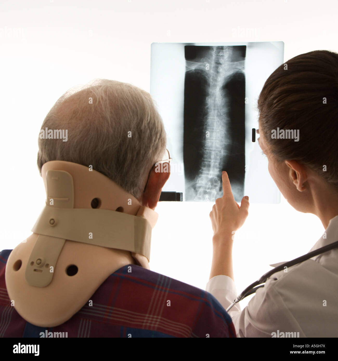 Over the shoulders view of mid adult Caucasian female pointing at an x ...