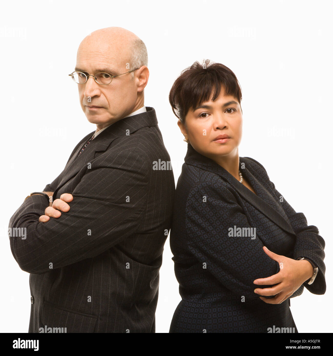 Caucasian middle aged businessman and Filipino businesswoman standing ...