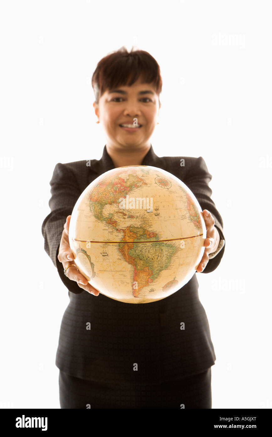 Filipino middle aged businesswoman holding globe in both hands standing ...