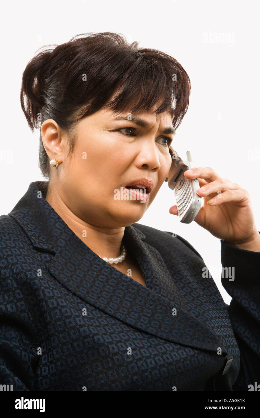 Filipino middle aged businesswoman talking on cellphone against white ...