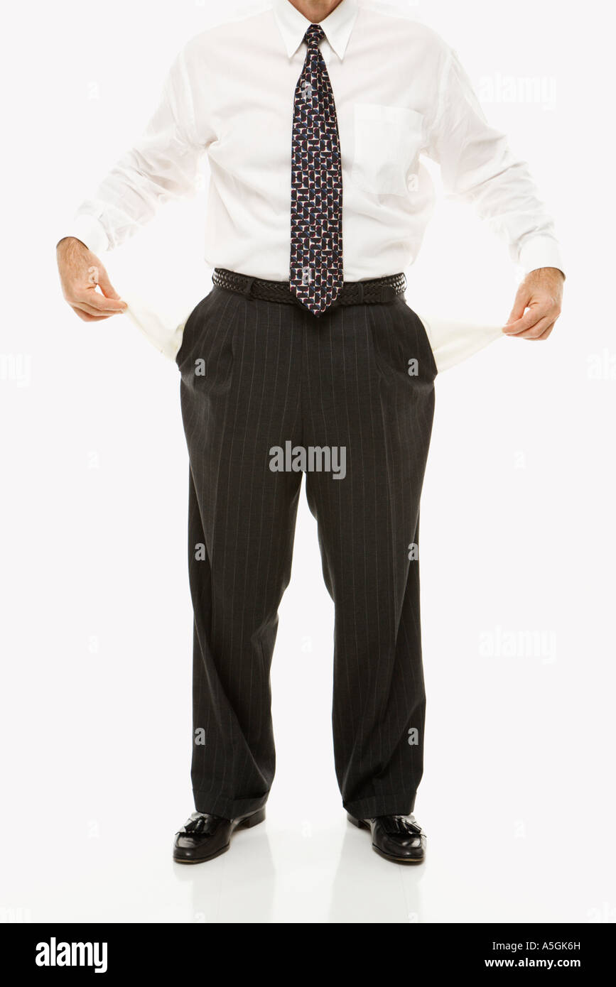 Caucasian middle aged businessman pulling empty pockets out standing ...