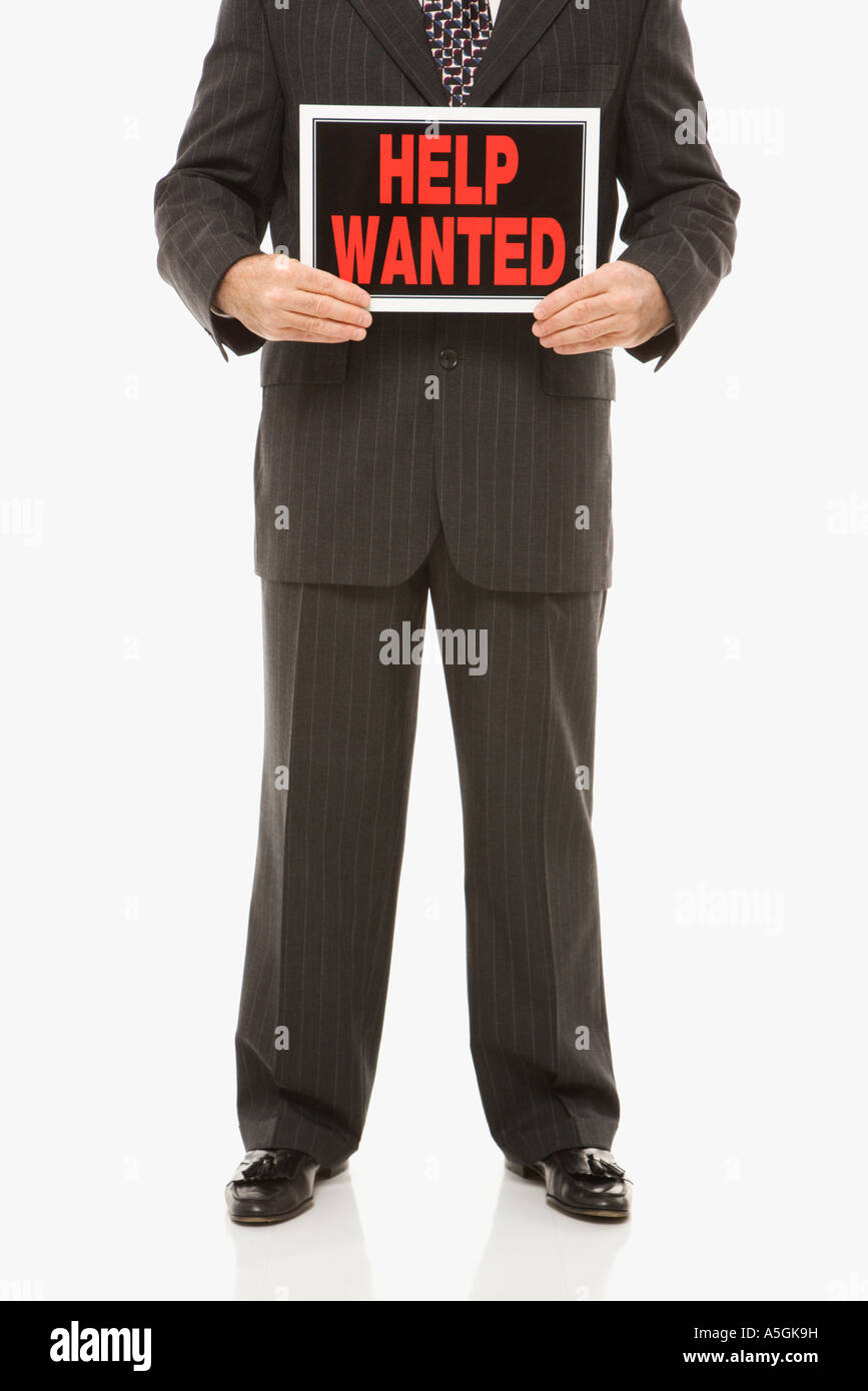 Caucasian middle aged businessman holding help wanted sign Stock Photo ...