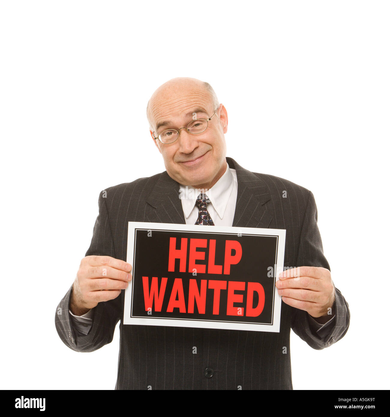 Caucasian middle aged businessman holding help wanted sign Stock Photo ...