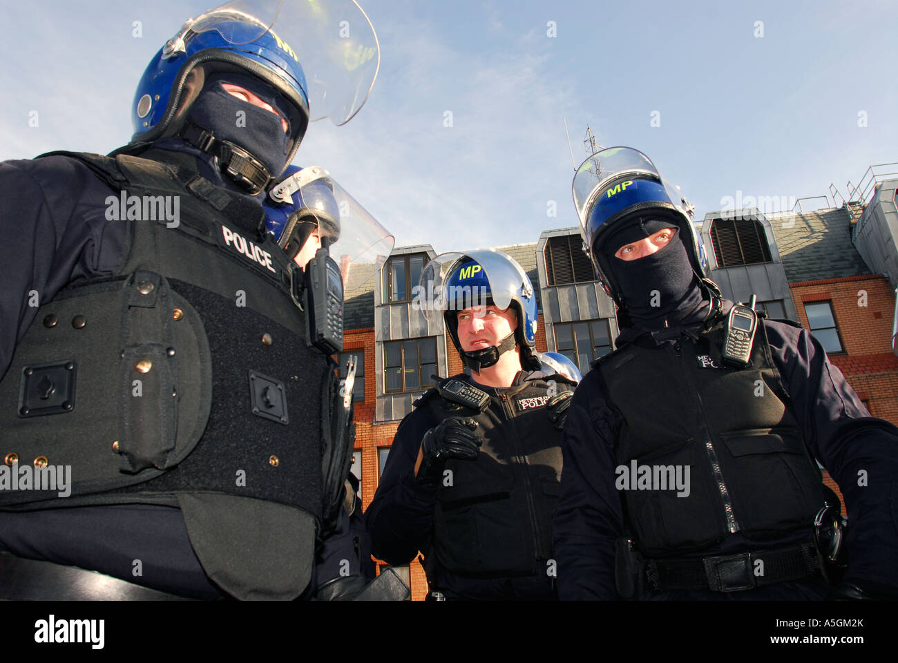 Police officers in riot gear preparing to leave police station to close ...