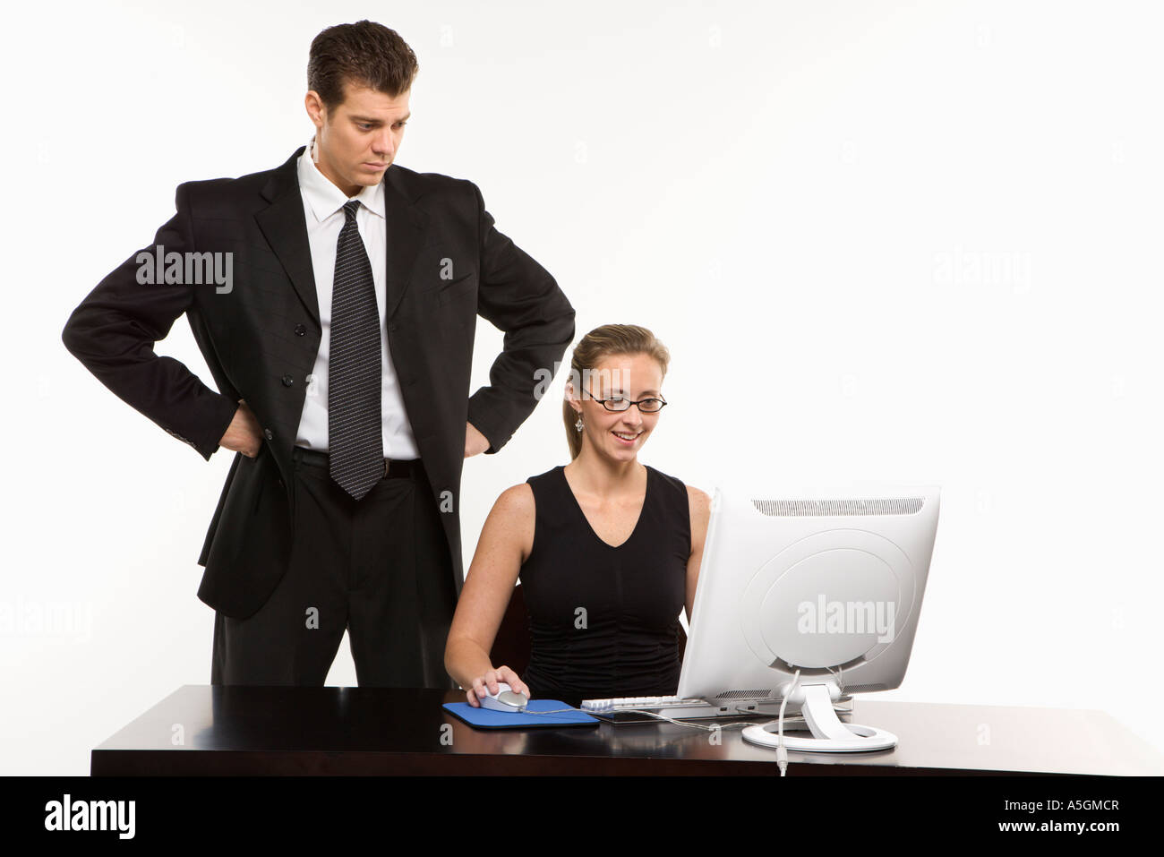 Caucasian mid adult man with hands on hips looking over shoulder of ...