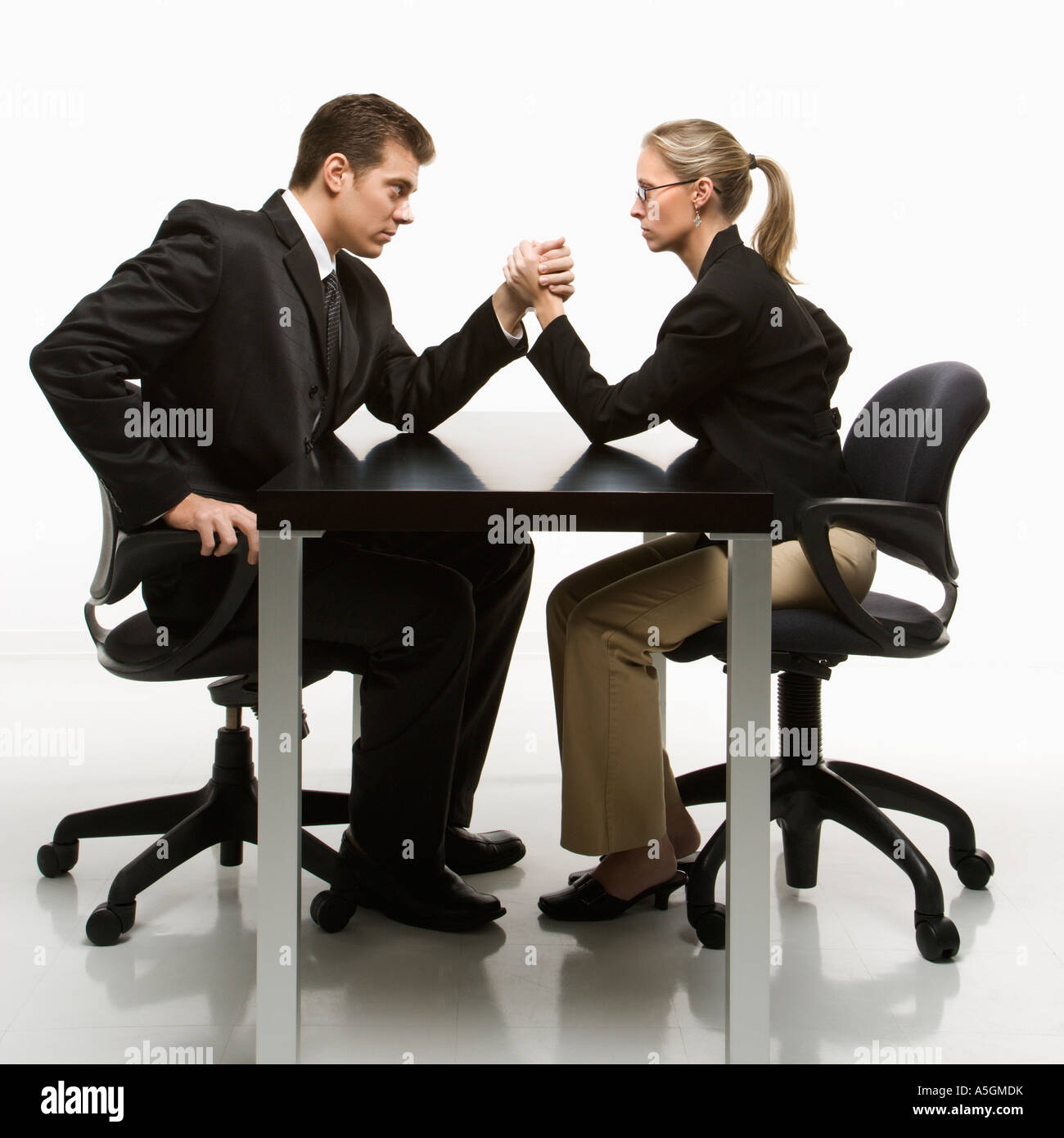 Side view of Caucasian mid adult businessman and businesswoman arm ...