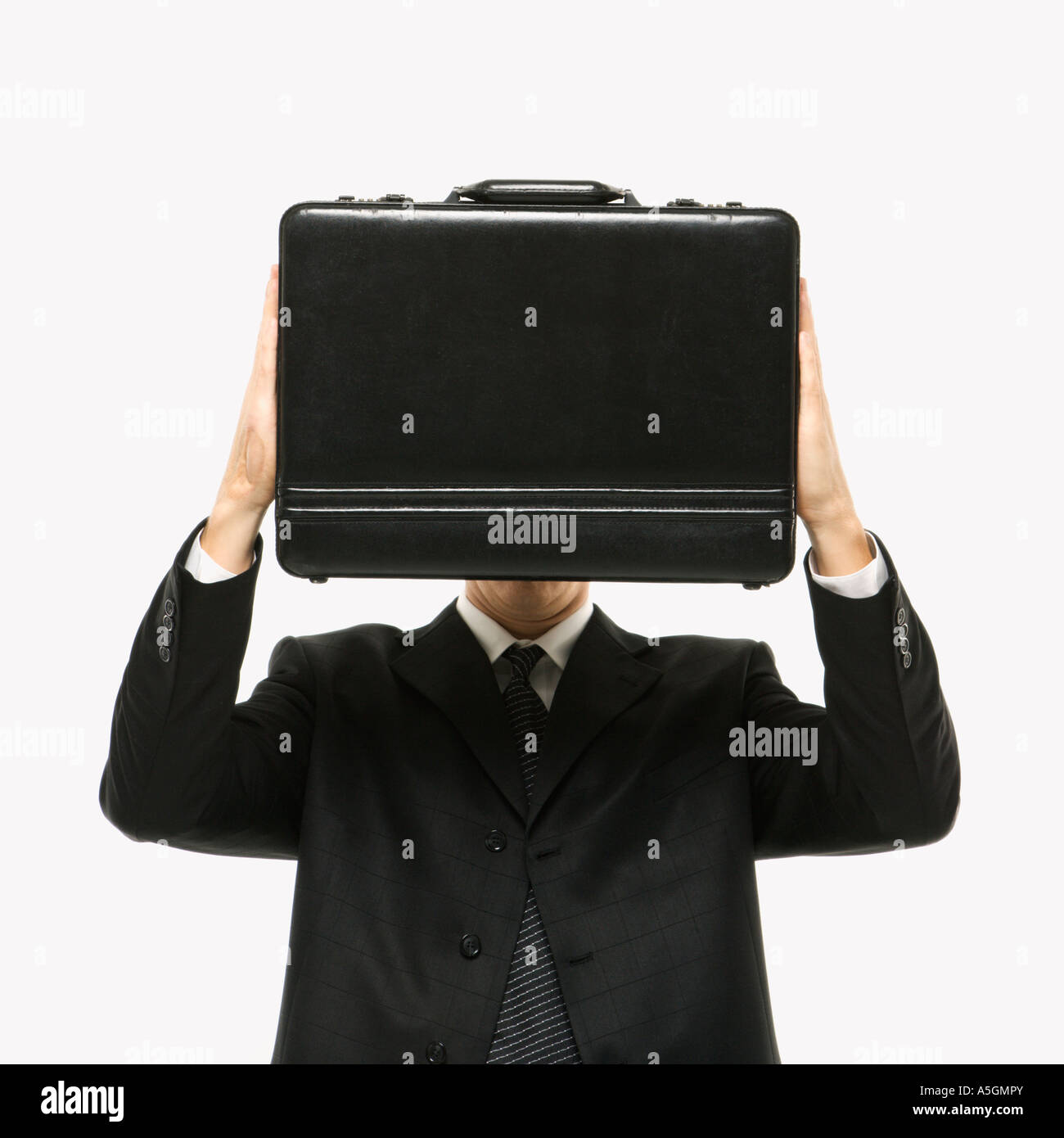 Caucasian man wearing suit and holding briefcase in front of face Stock ...