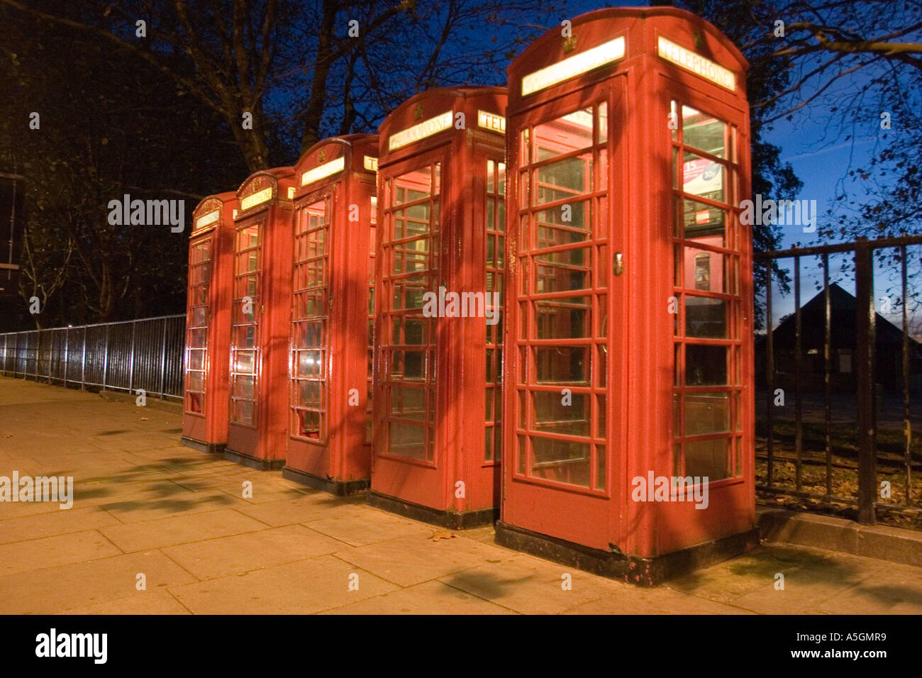 Red London telephone boxes at night Stock Photo - Alamy