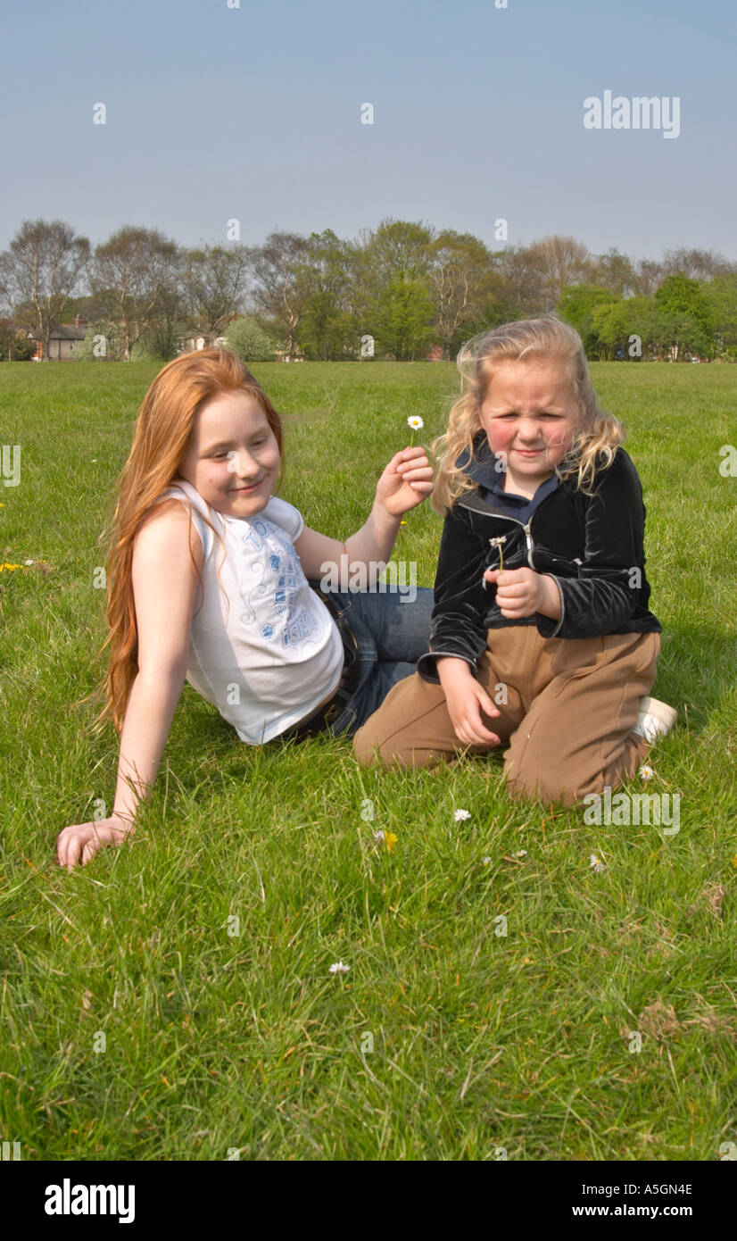 Two sisters enjoying a day out in the park Stock Photo - Alamy