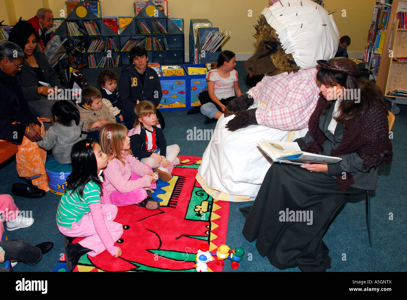 Parents with their children during half term listening to a book ...