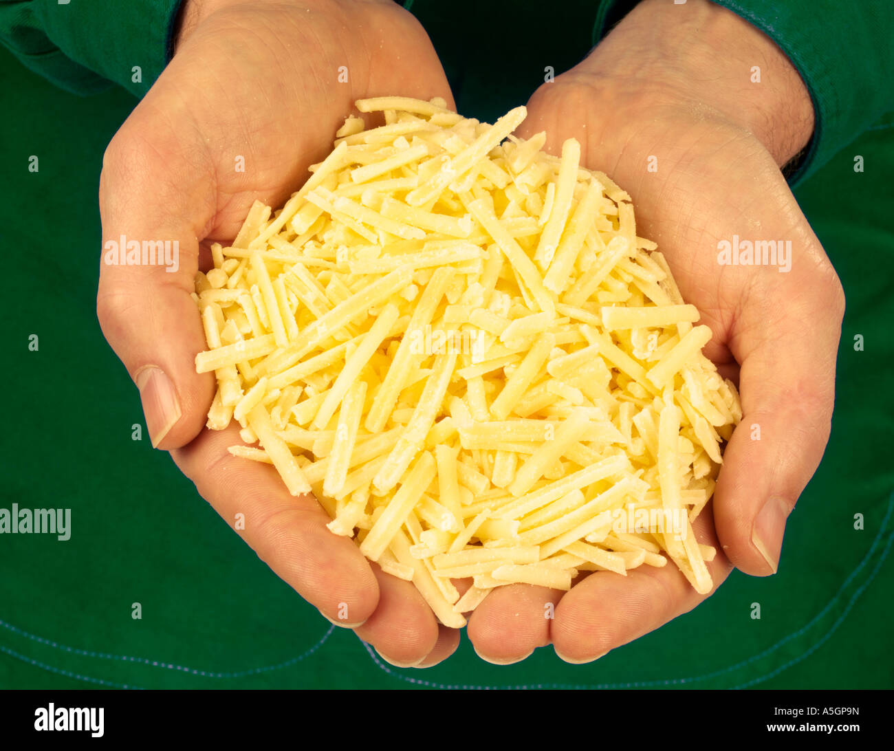 HANDFUL OF GRATED CHEDDAR CHEESE Stock Photo - Alamy