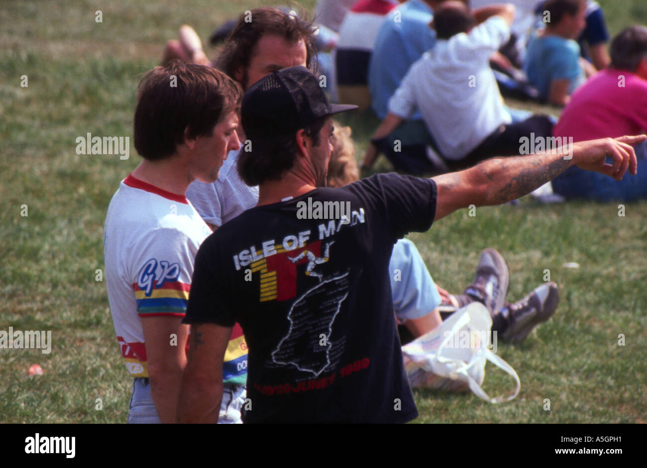 Two men watching motorcycle race Isle of Man Stock Photo - Alamy