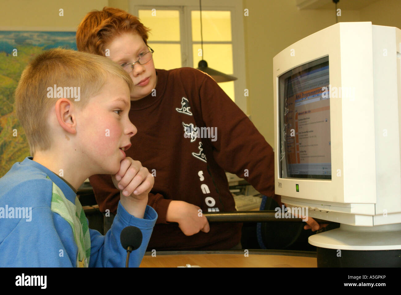 two young boys working at a computer Stock Photo - Alamy