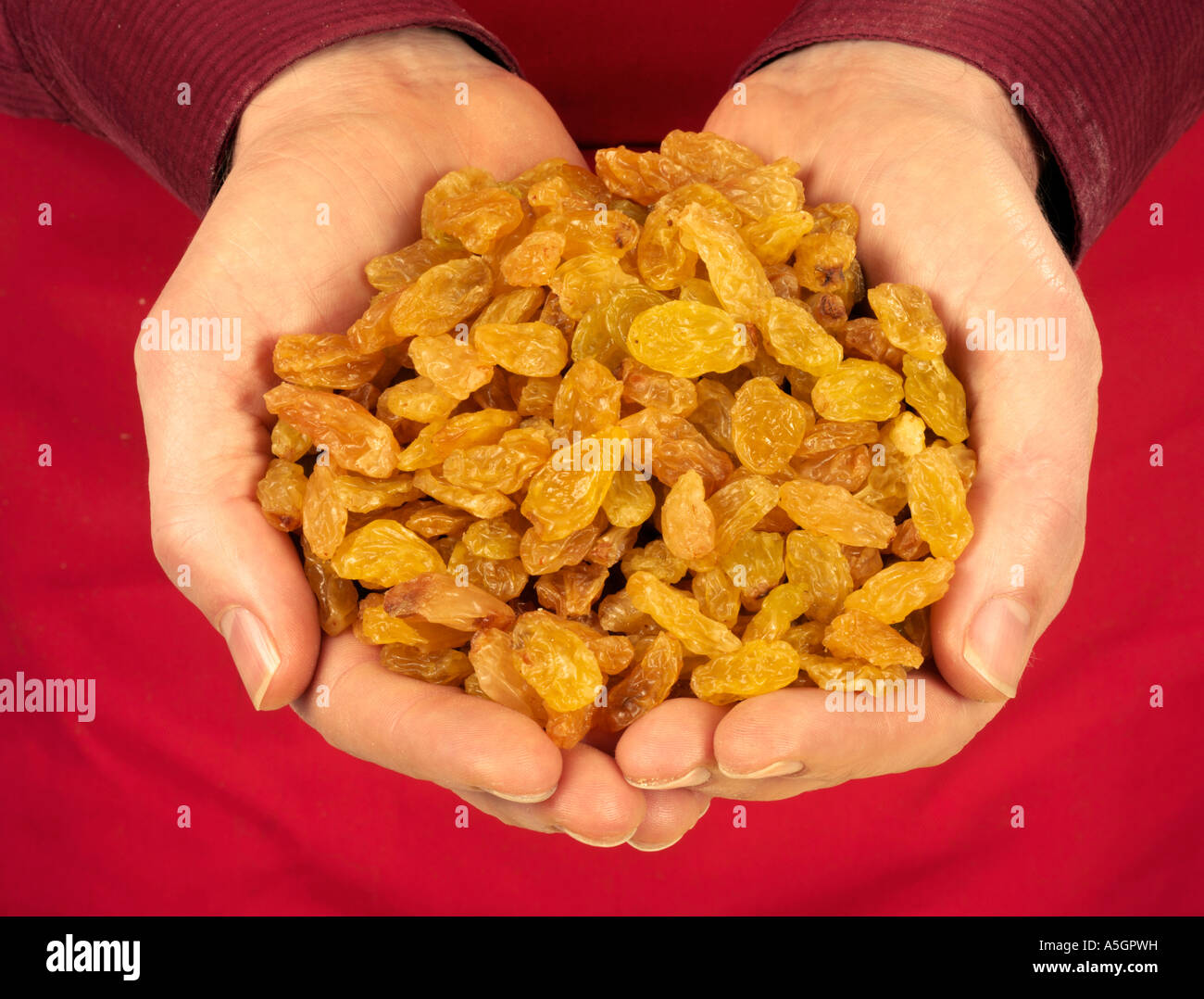 MAN HOLDING GOLDEN RAISINS Stock Photo - Alamy